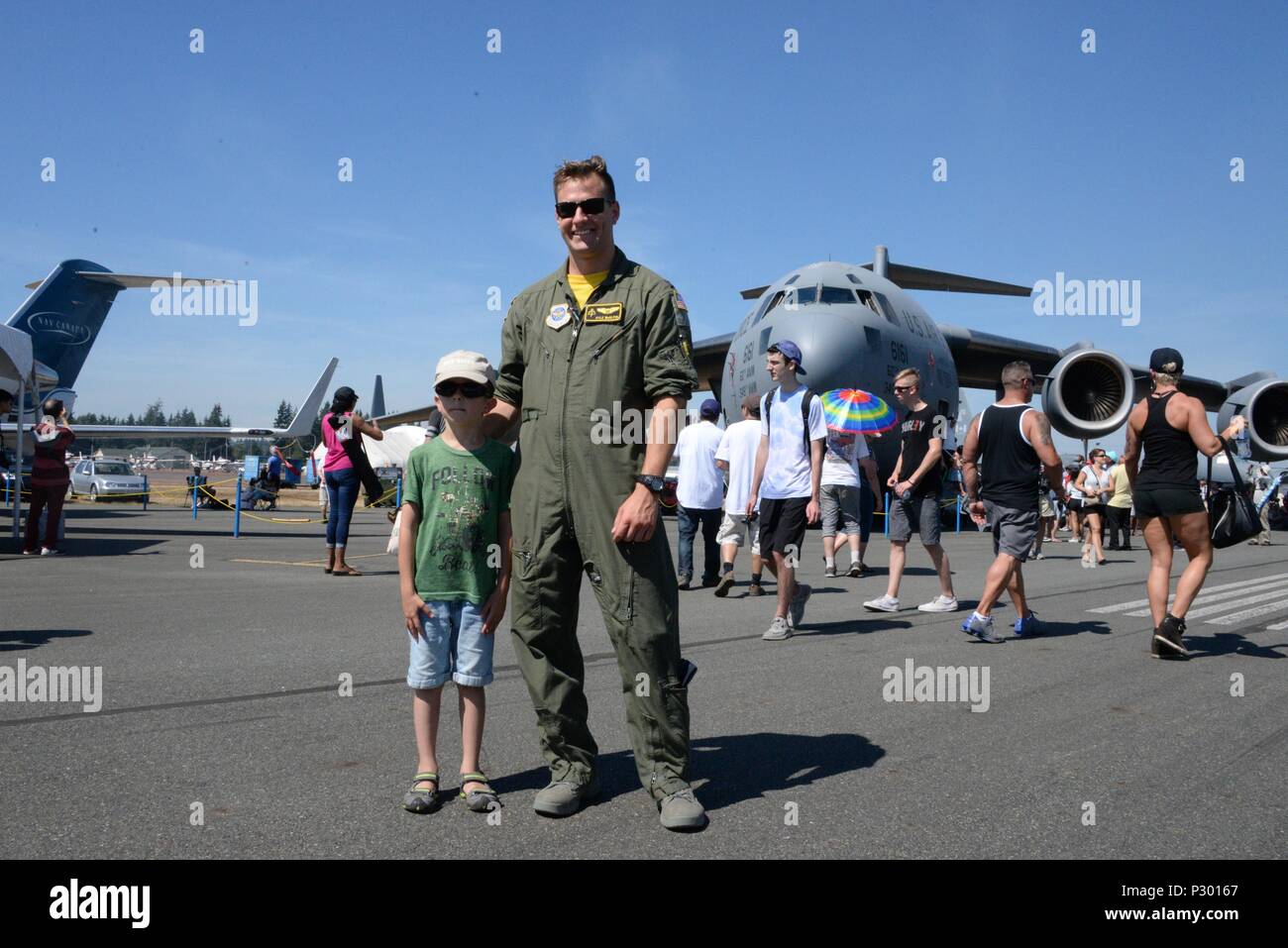 Capt. Kyle McAplin, 21st Airlift Squadron pilot, poses with a visitor ...