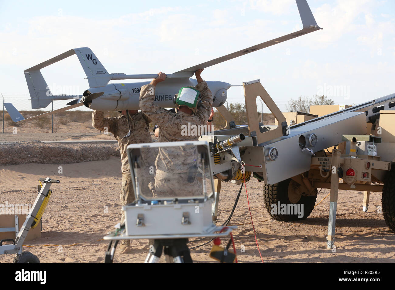 Marines with Marine Unmanned Aerial Vehicle Squadron (VMU) 1 load their ...