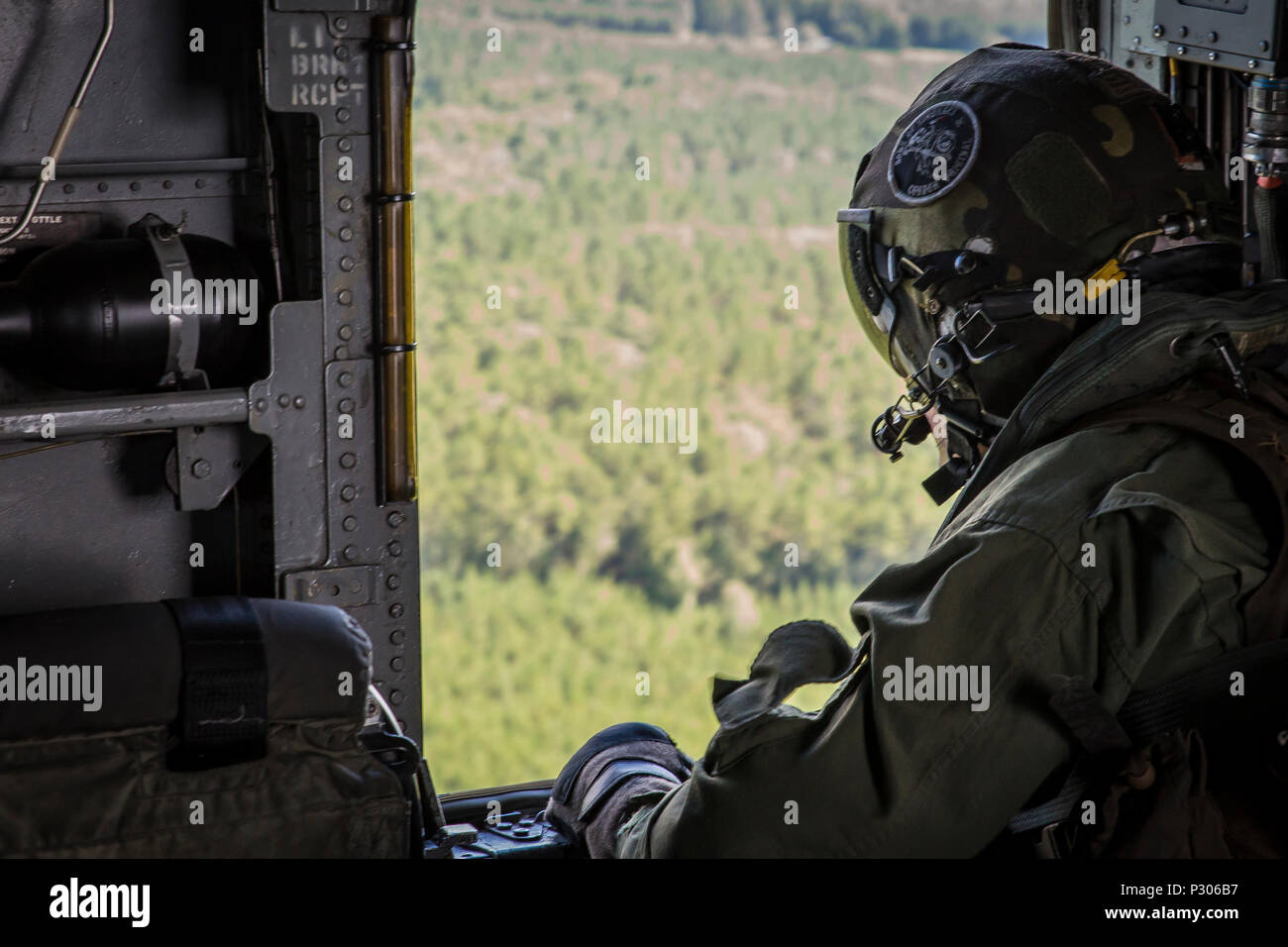 A Marine rides aboard CH-53E Super Stallion during Exercise Arrowhead ...
