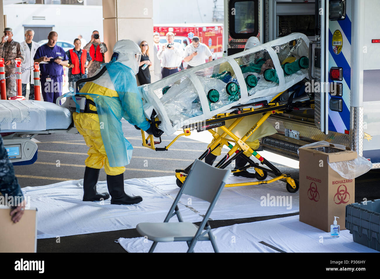 A simulated Ebola patient in an isolation pod is removed from an ...