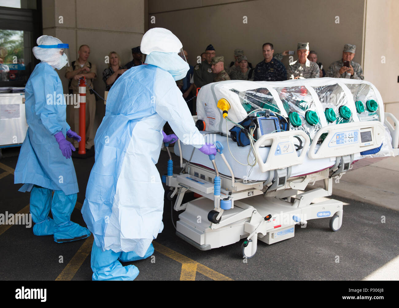 A simulated Ebola patient in an isolation pod is brought into Walter ...