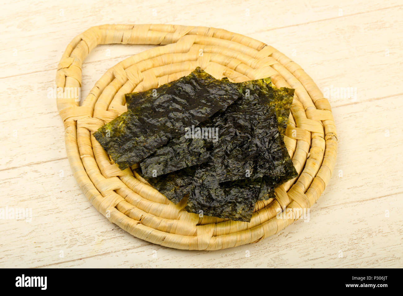 Crispy Nori sheets chips over wooden background Stock Photo - Alamy