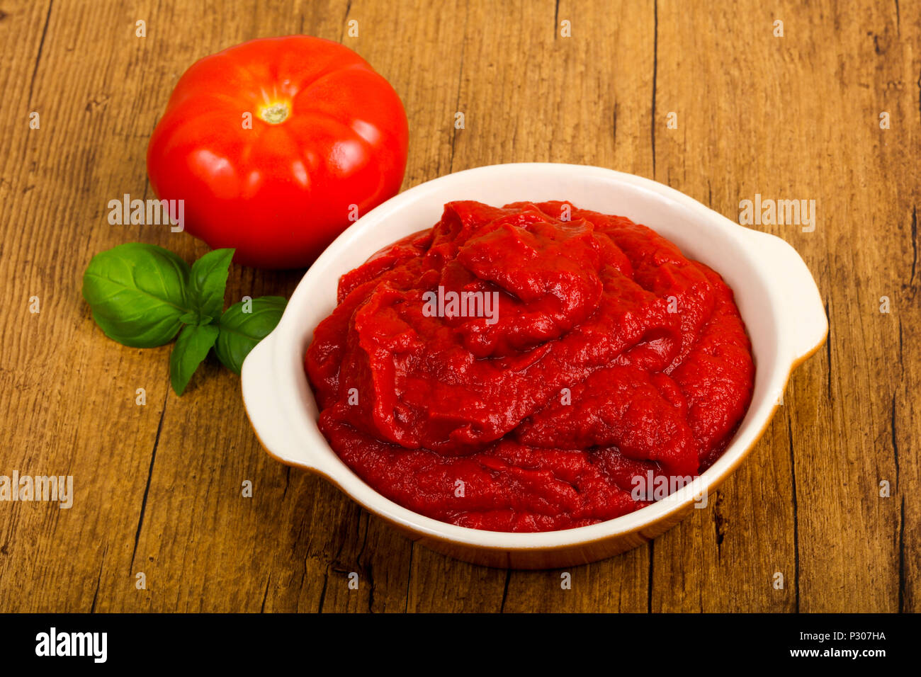 Tomato paste with basil leaves Stock Photo - Alamy