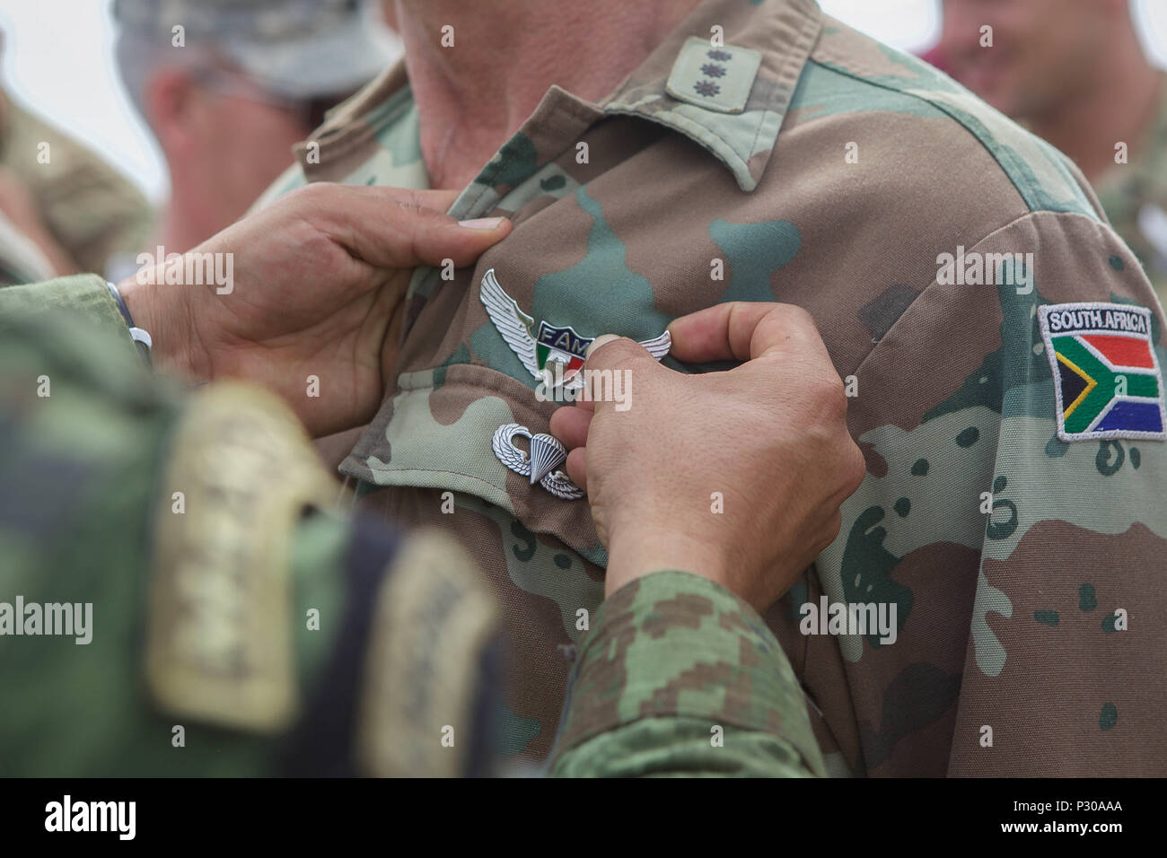 A Mexican Jumpmaster pins Mexican jump wings onto a South African ...