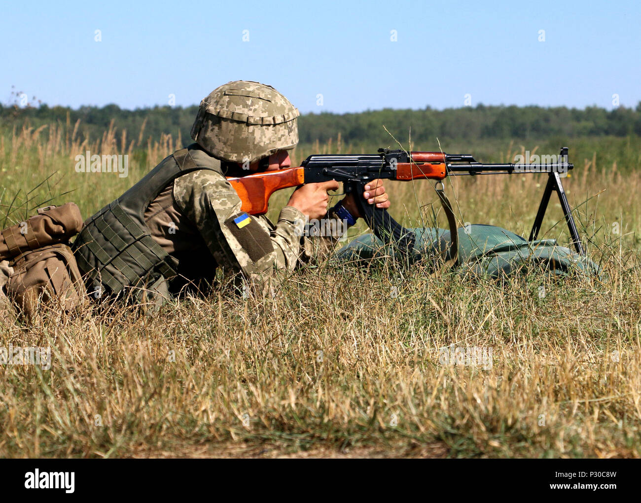 YAVORIV, Ukraine - A Ukrainian Soldier shoots an RPK (Ruchnoy Pulemyot ...