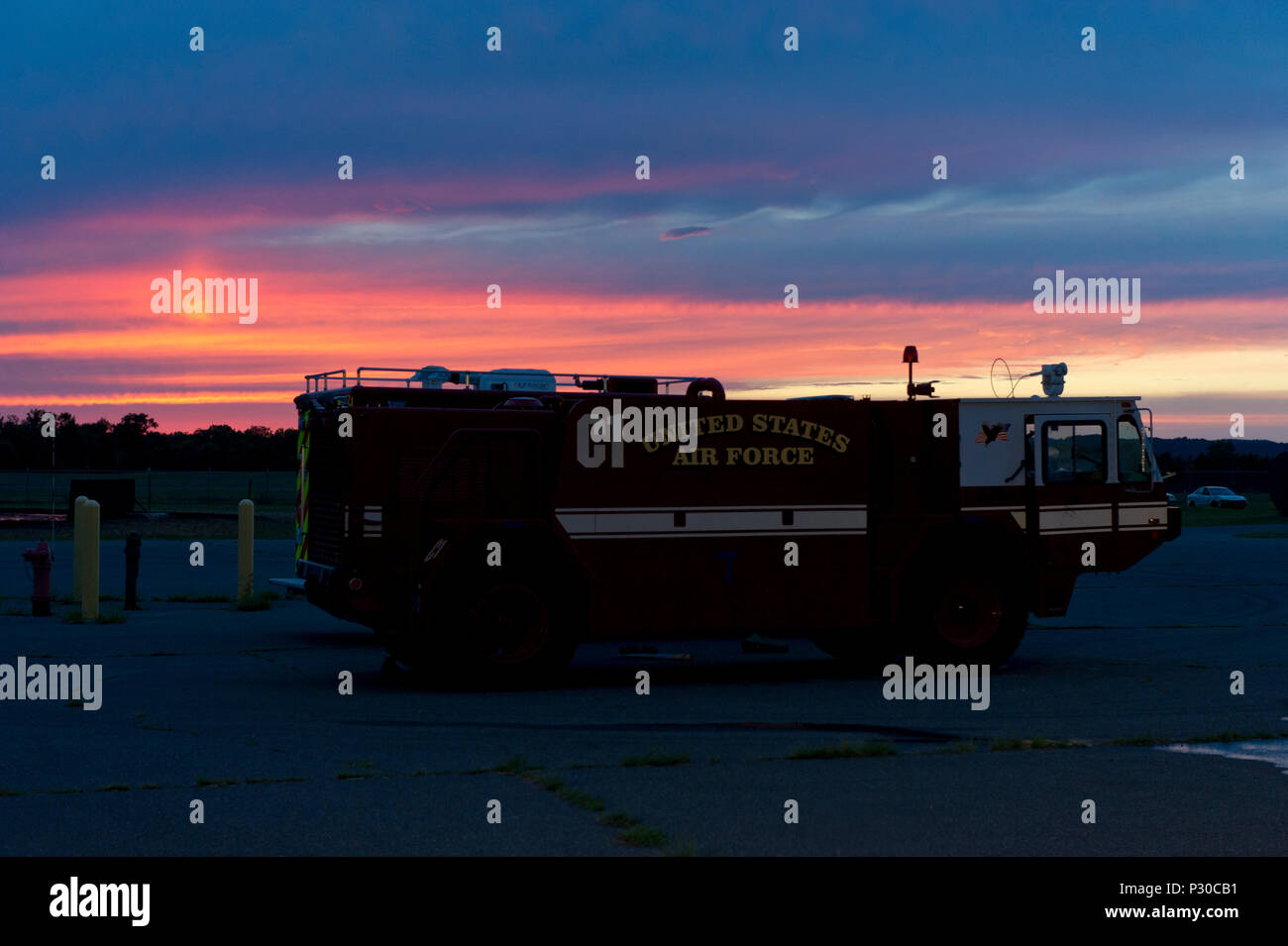 A U.S. Air Force fire engine sits during nighttime firefighting ...
