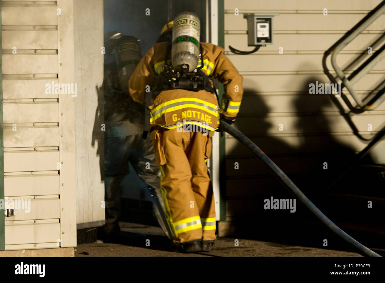 U.S. Air Force firefighters enter a live fire training structure during ...