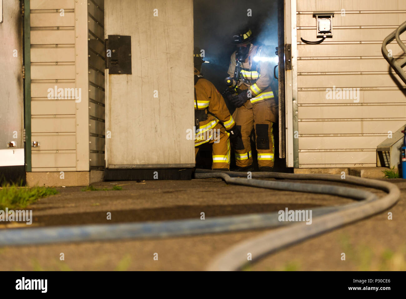 U.S. Air Force firefighters enter a live fire training structure during ...