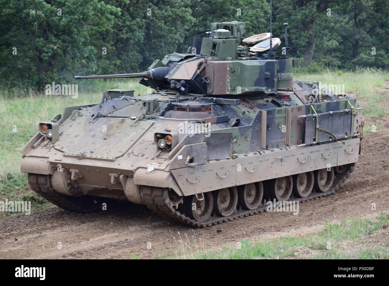 A Bradley Fighting Vehicle moves through the field to suppress while ...