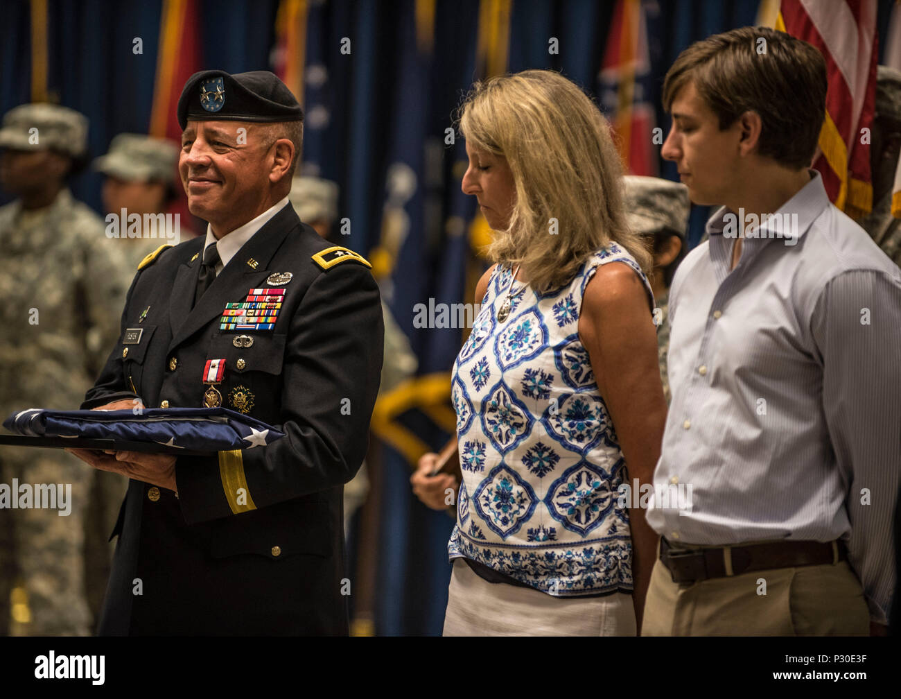 Maj. Gen. (ret.) David Puster is presented with the National Flag for ...