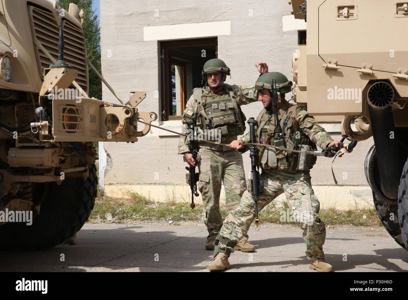 Georgian soldiersof the 32nd Infantry Battalion prepare to tow vehicle ...