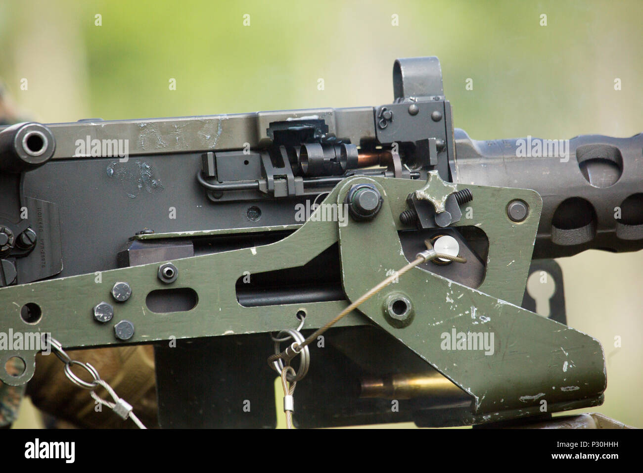 An M2 machine gun sits over fired .50 caliber casings after firing ...