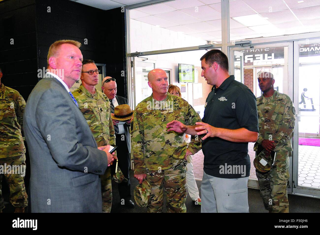 Lt. Gen. Kenneth Dahl, center, listens as Dan Gauvin, facility manager ...