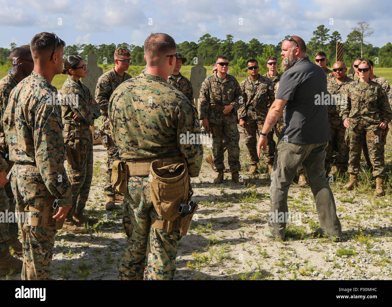 A Department of Defense marksmanship instructor teaches Marines with ...