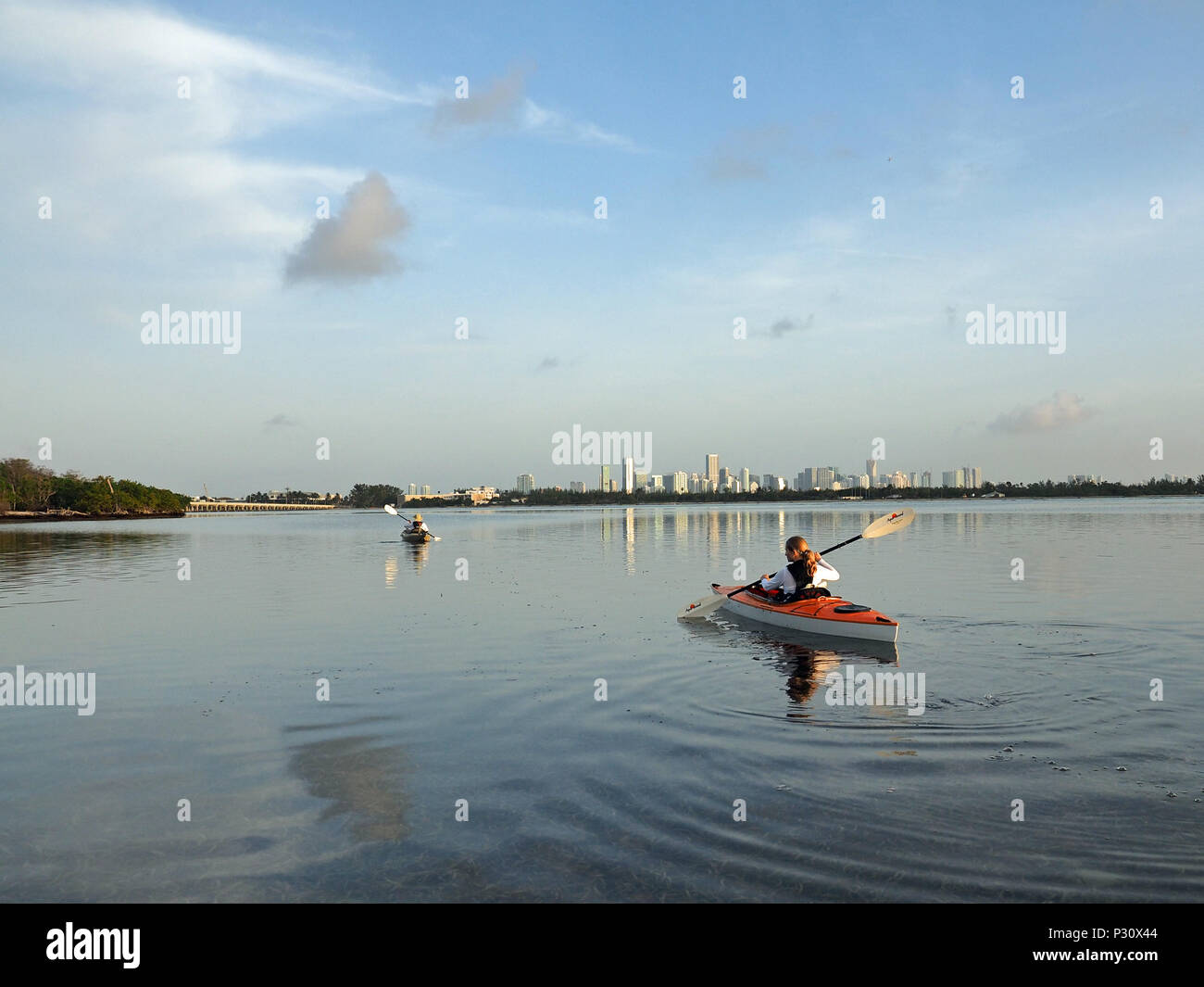 Woman kayaking and photographing the sunrise in Bear Cut off Key ...