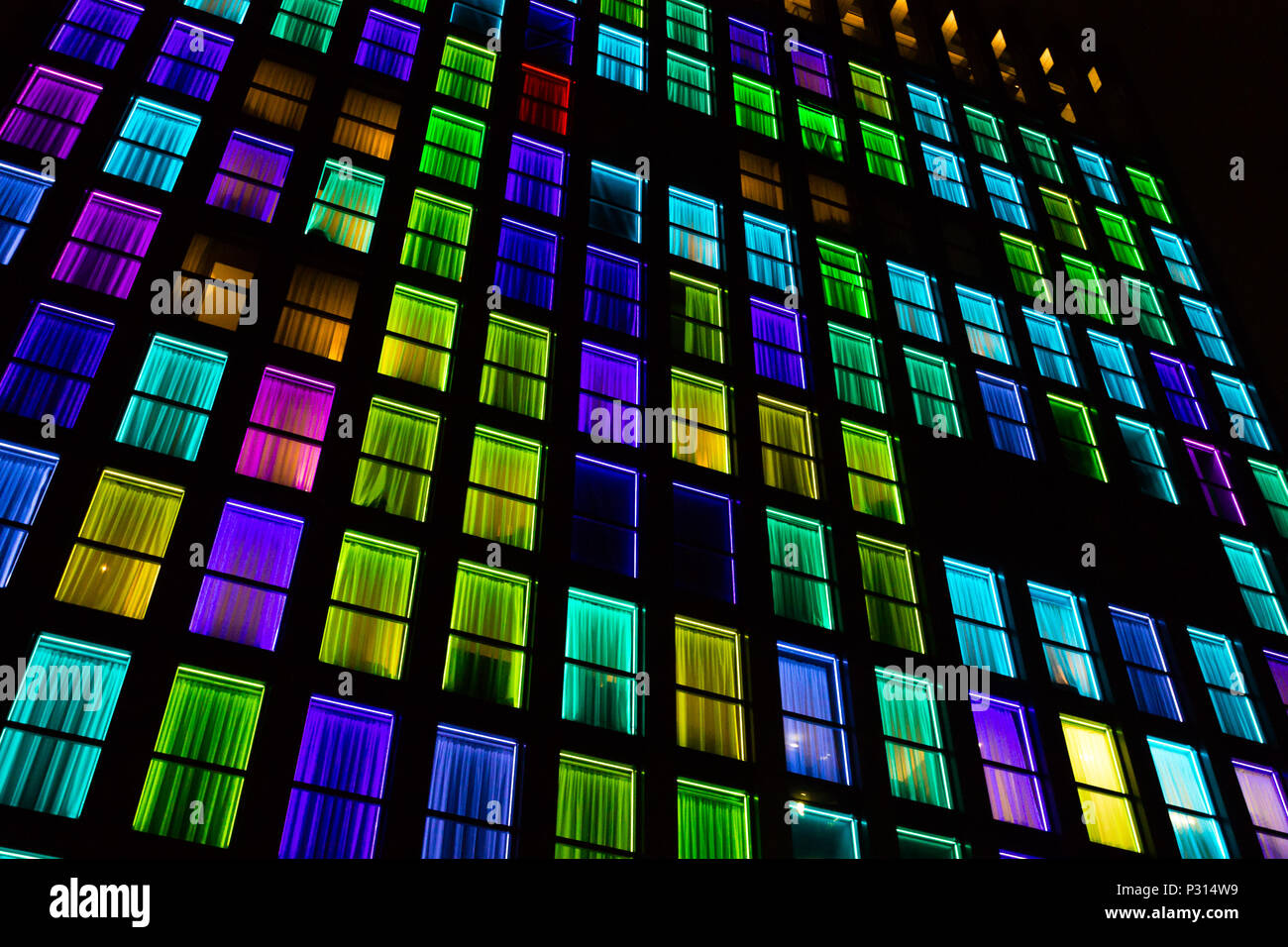 Colored windows texture. Windows illuminated by neon lights background ...
