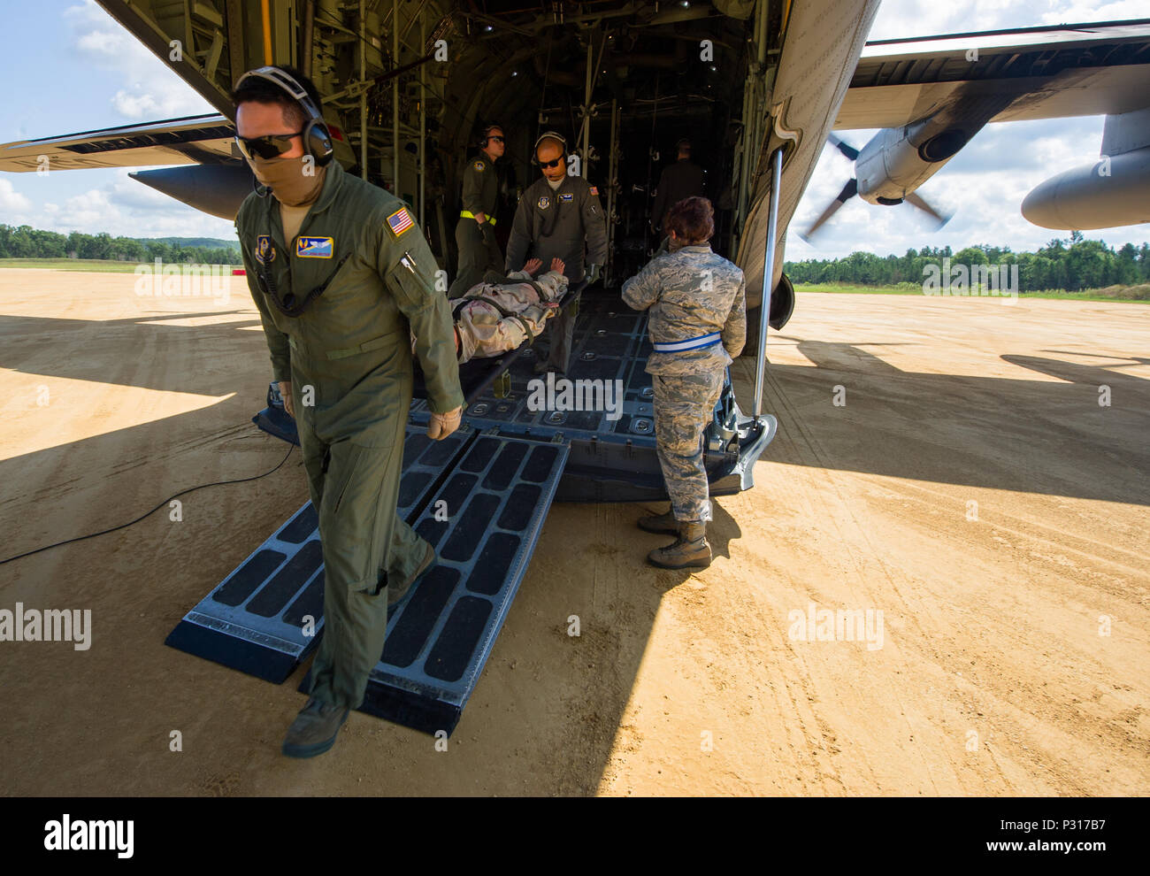 U.S. Airmen practice transferring patients and medical gear from a bus ...