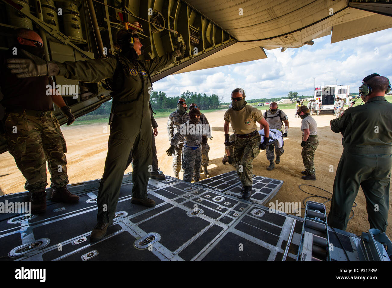U.S. Airmen practice transferring patients and medical gear from a bus ...