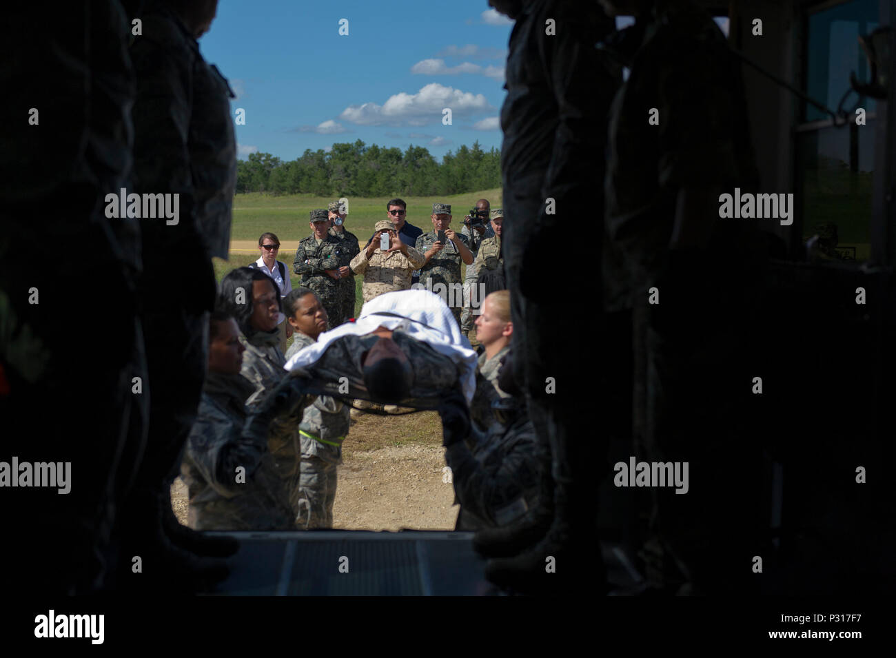 U.S. Airmen and British Royal Air Force medical personnel load a ...