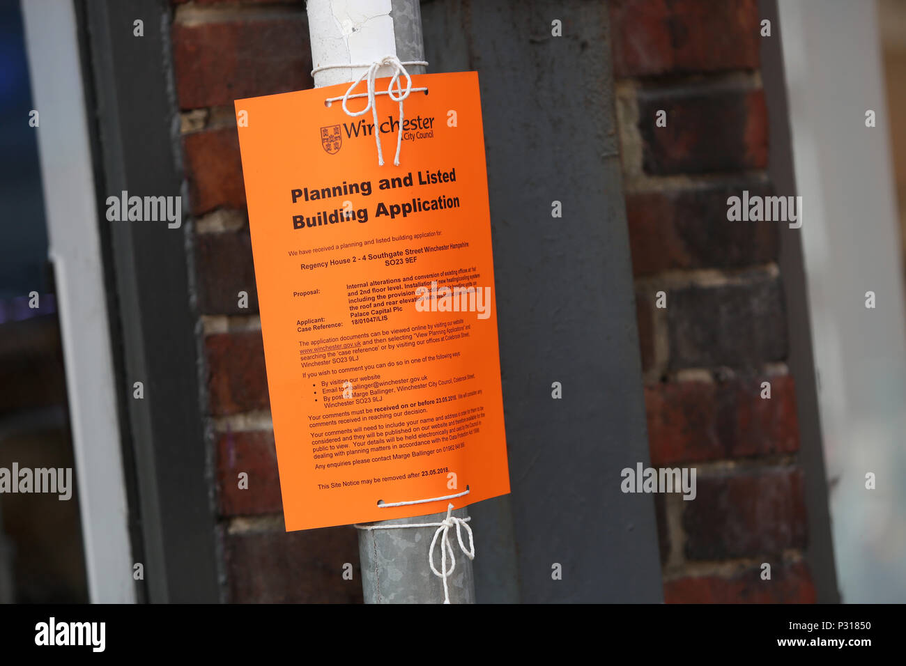 A planning and listed building application notice attached to a lamp ...