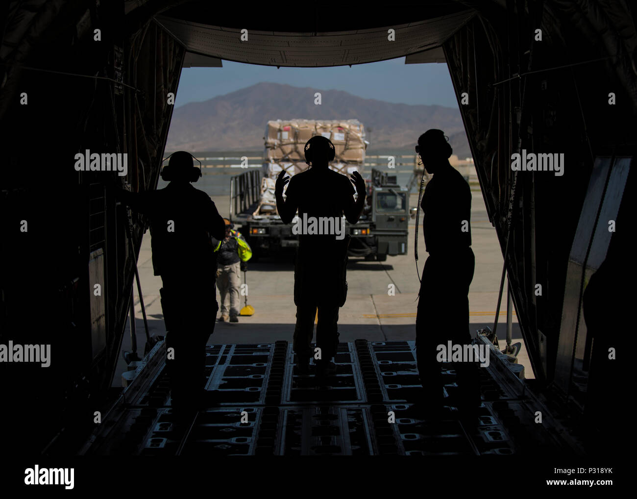 Senior Airman Andrew Garrett (center), 774th Expeditionary Airlift ...