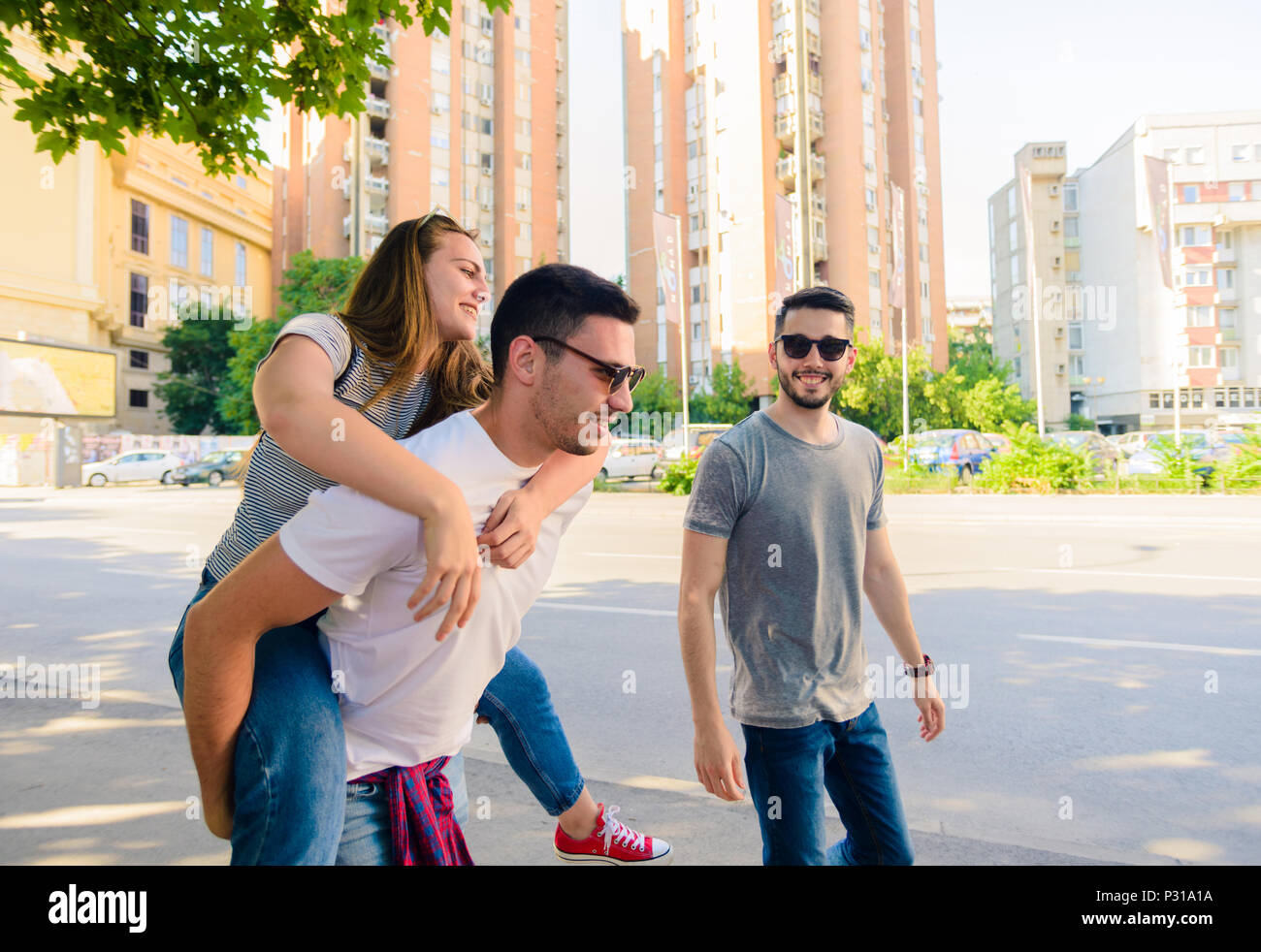 Happy young people walking down the city street and having fun Stock ...
