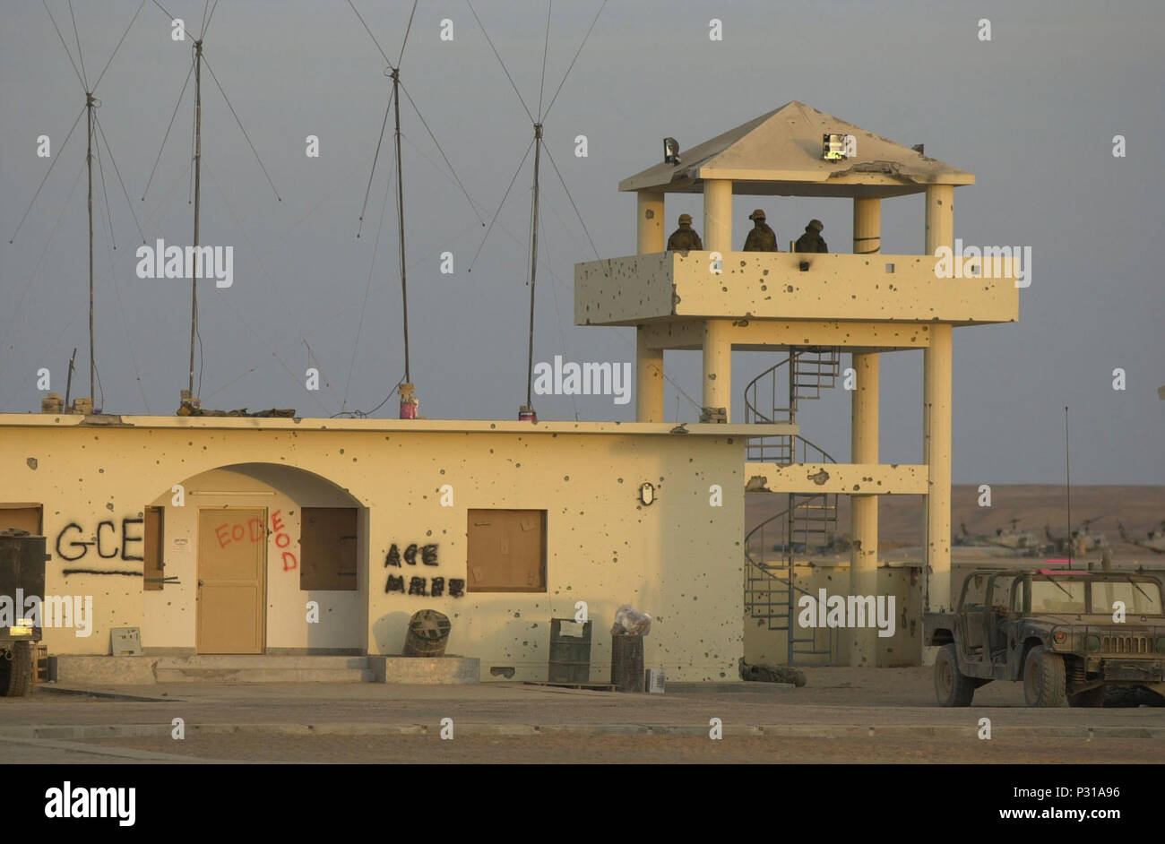 Camp Rhino, Afghanistan (Dec. 2, 2001) -- A bullet-riddled tower stands ...