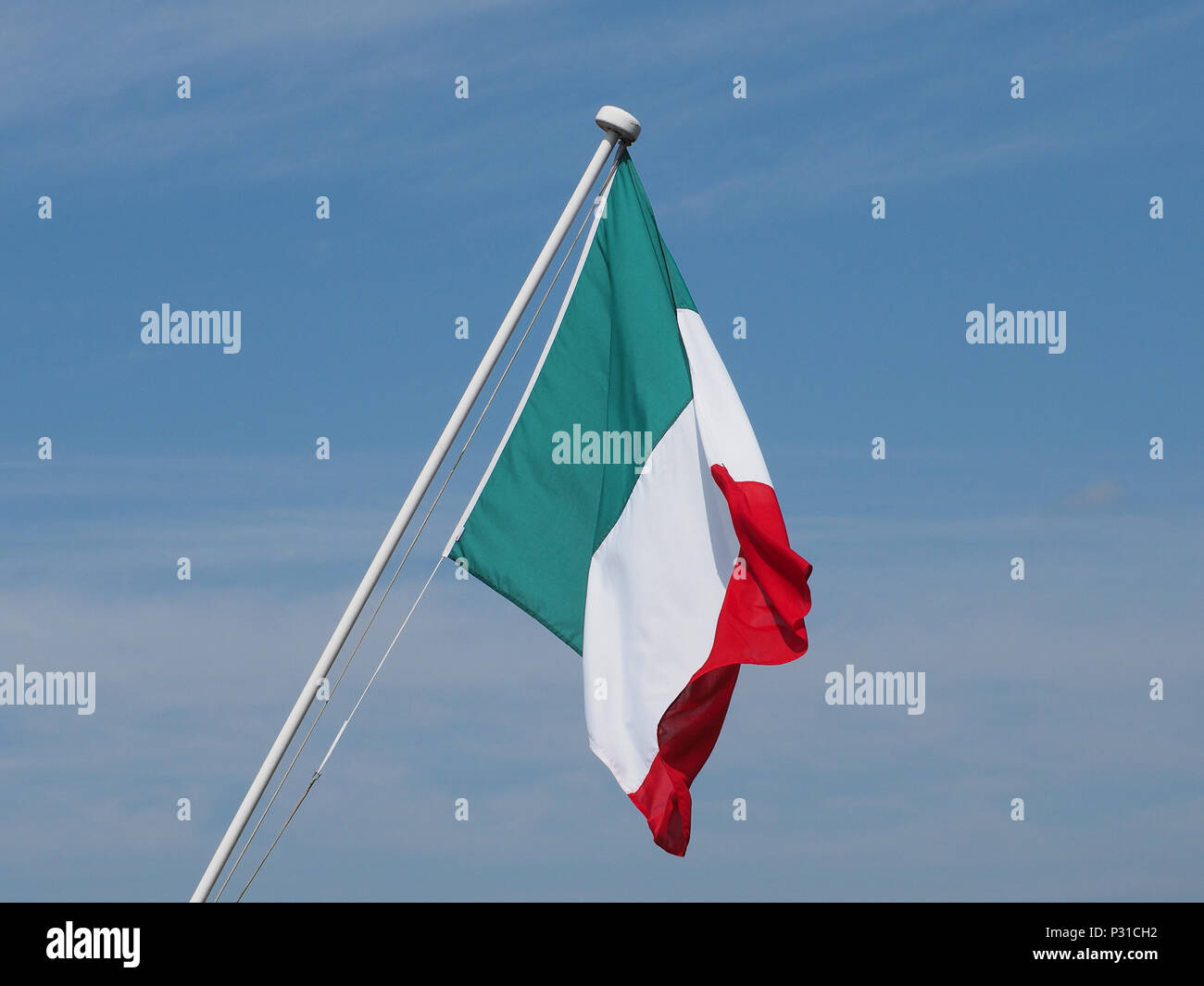 the Italian national flag of Italy, Europe over blue sky Stock Photo ...