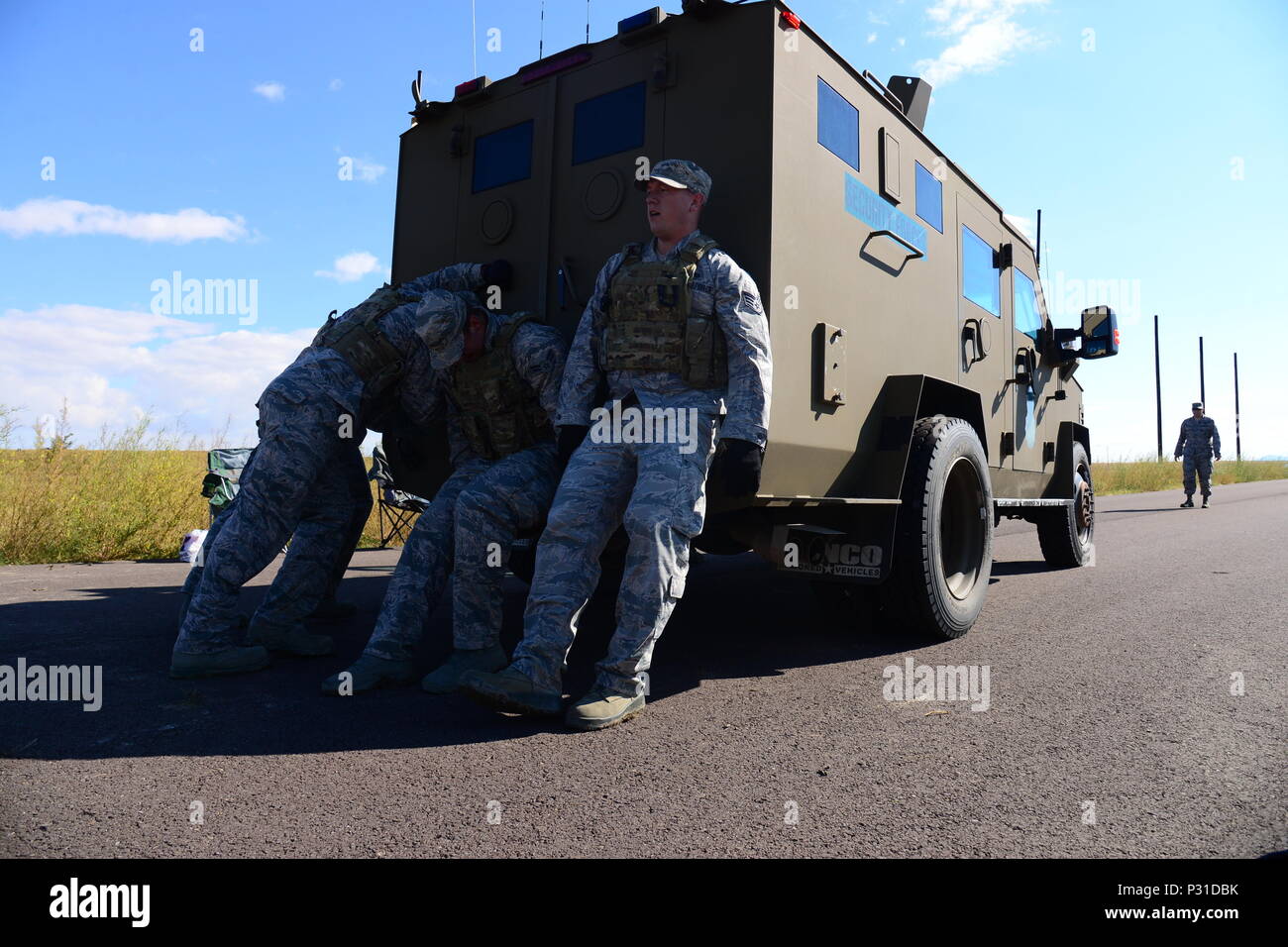 Airmen assigned to the 341st Security Forces Group, push a Humvee ...
