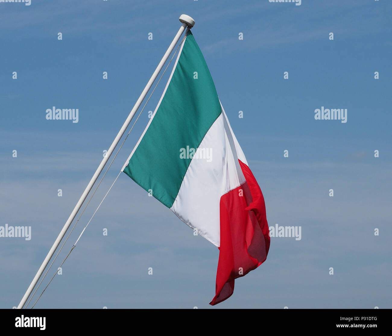 the Italian national flag of Italy, Europe over blue sky Stock Photo ...