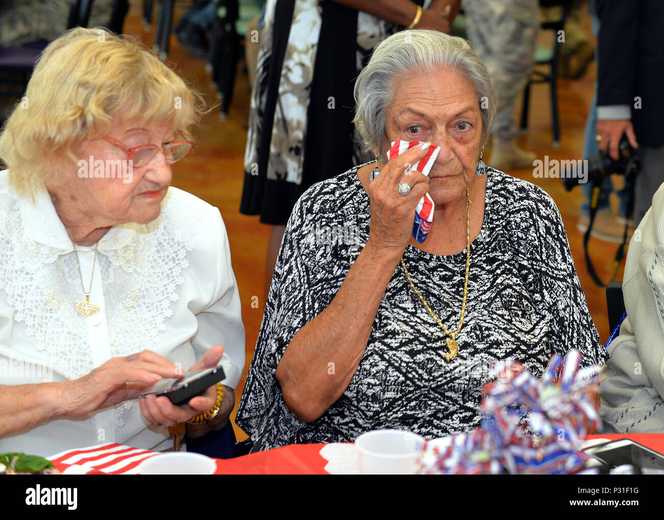 U.S. Army WWII veteran Debra Stern, right, sheds a tear after being ...