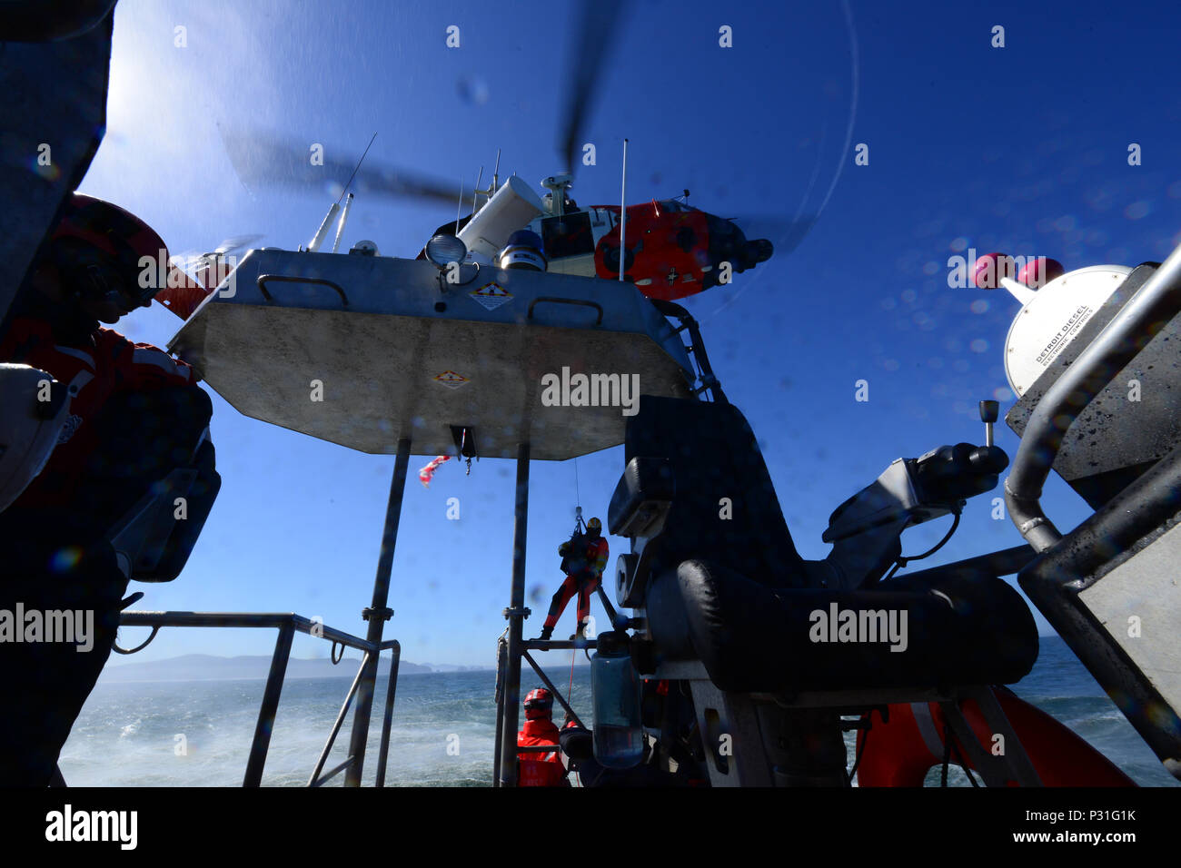 An MH-60 Jayhawk helicopter aviation survival technician is lowered ...