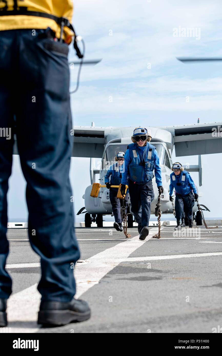 PHILIPPINE SEA (Aug. 22, 2016) Sailors carry chocks and chains on the ...