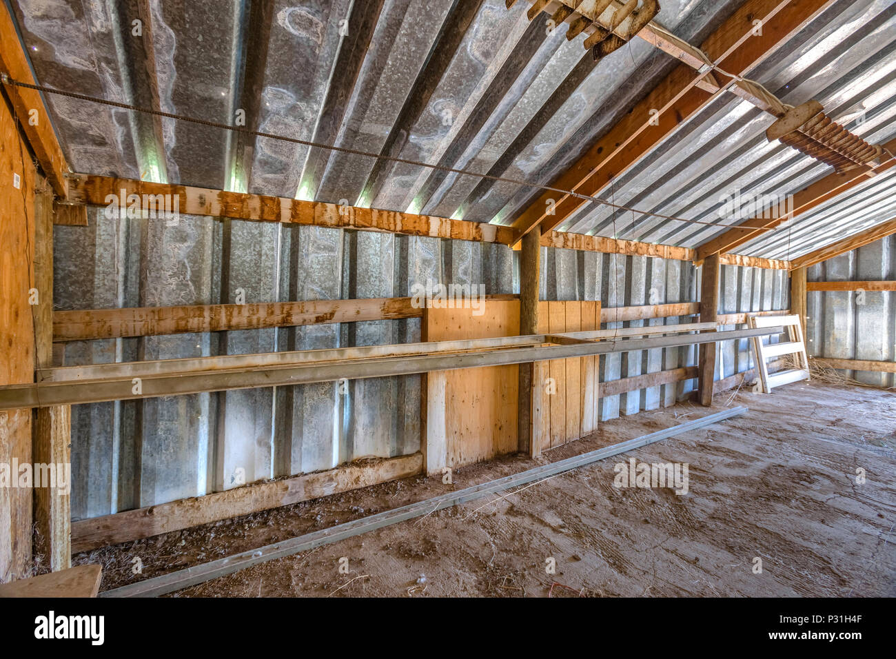 Interior edge of barn with metal walls Stock Photo - Alamy