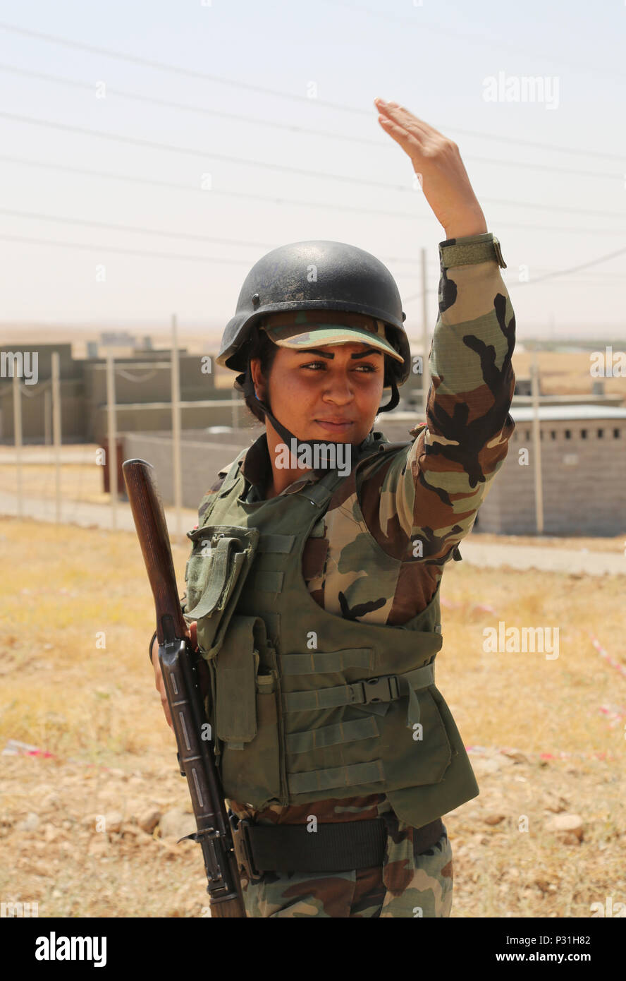 A Zeravani soldier motions for her squad to begin movement during a ...