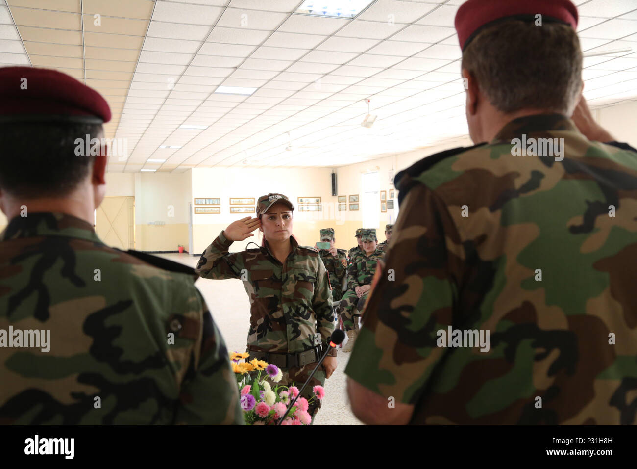 A Zeravani soldier salutes before receiving her certificate during a ...