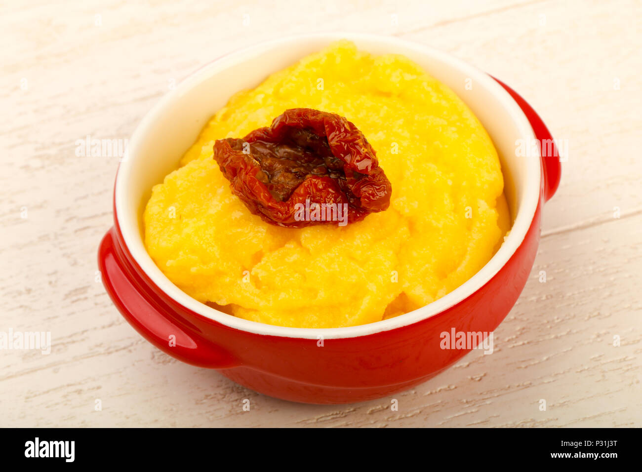 Polenta with dry tomato Stock Photo - Alamy
