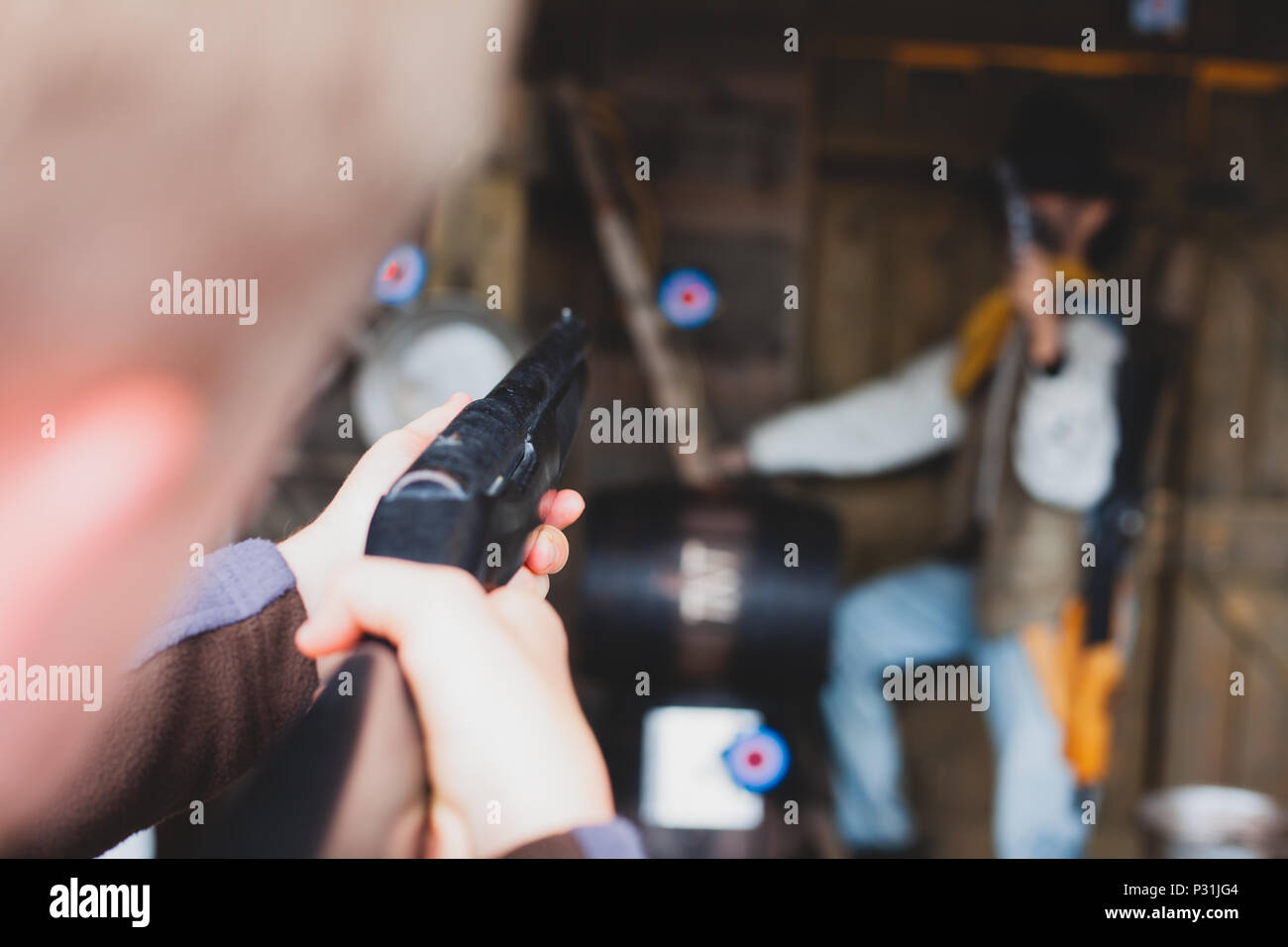 Practice firing with a rifle. Shooting with a rifle in a fun park ...