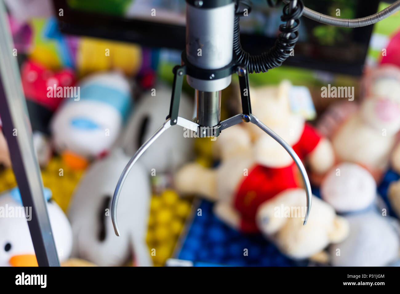Claw crane capture device in the amusement park for the kids. Toy ...