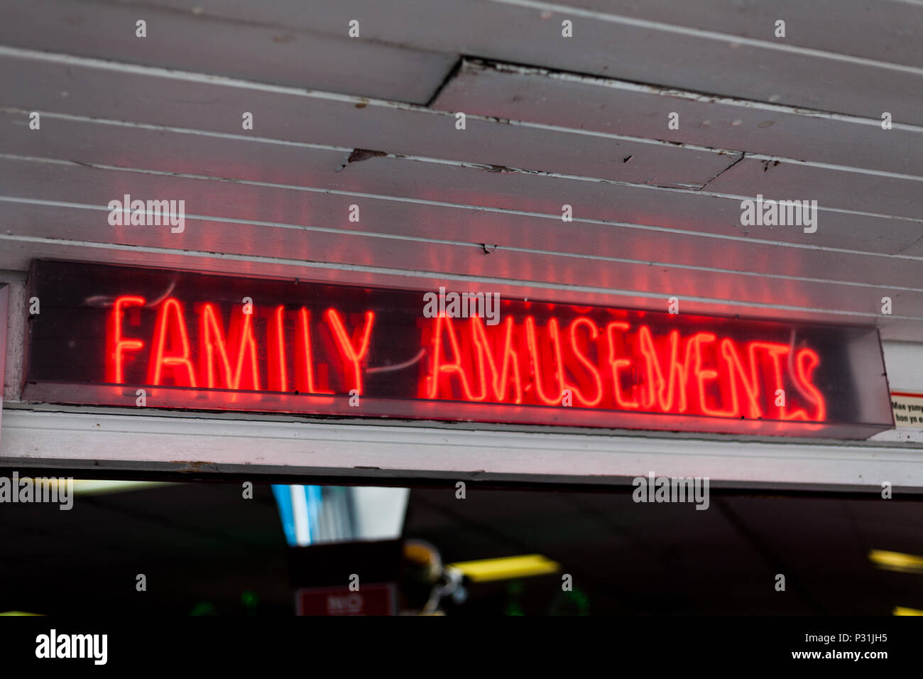 Family amusements sign on the street. Leisure concept with neon lights ...