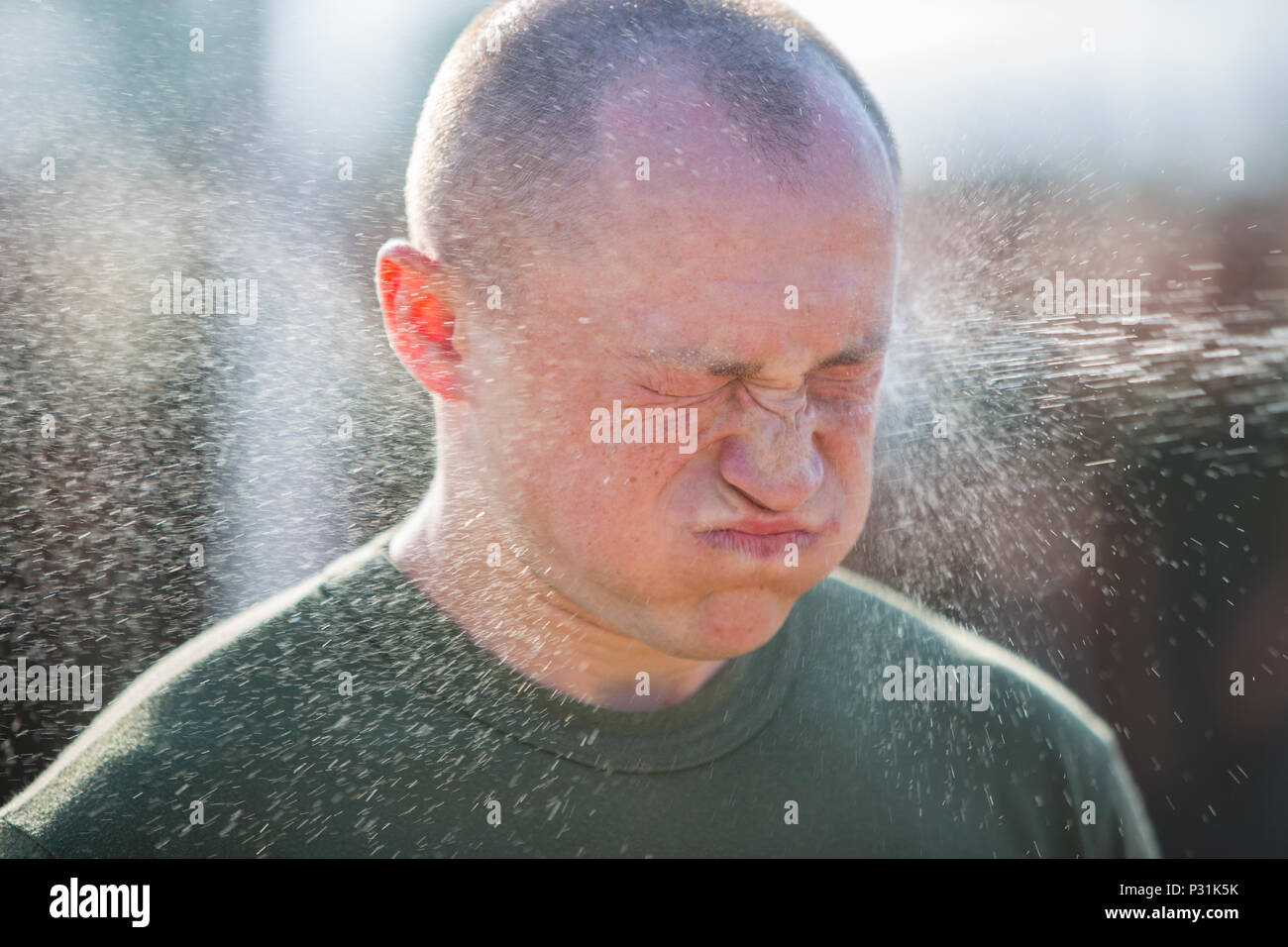U.S. Marine Corps Lance Cpl. Aleksander Lopuga is sprayed with ...