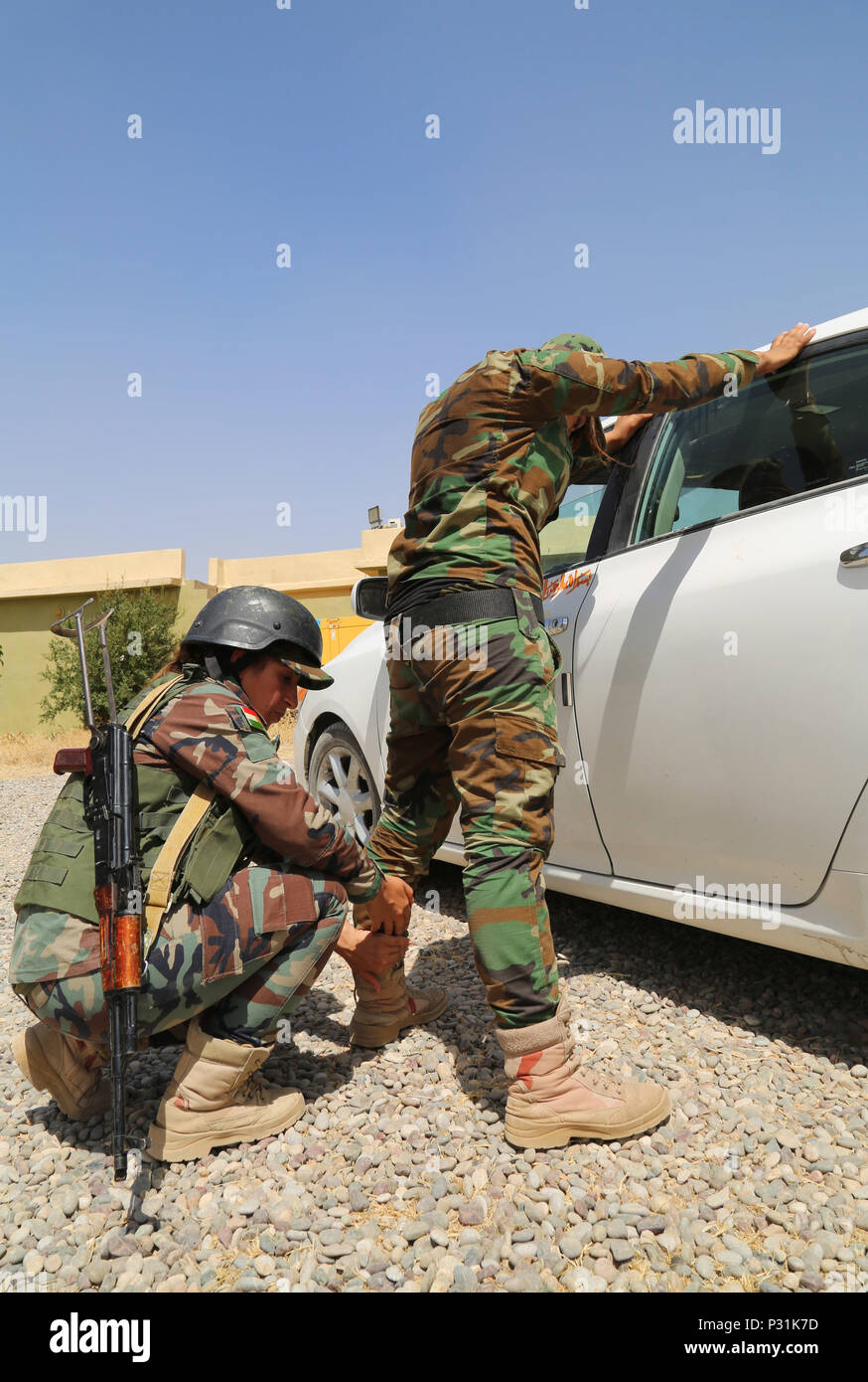 A Zeravani soldier searches a simulated civilian during a checkpoint ...