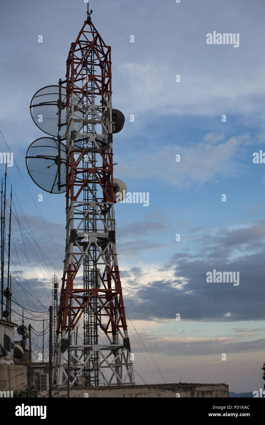 An network tower standing tall near the cliff besides a sandy beach ...
