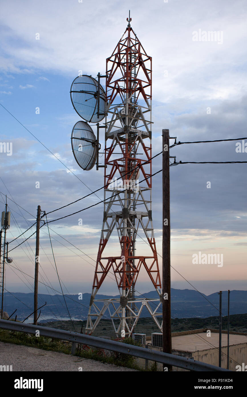 An network tower standing tall near the cliff besides a sandy beach ...