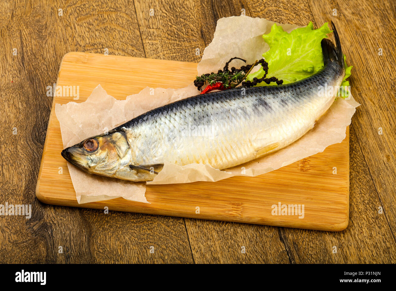 Salted Herring fish with pepper and spices Stock Photo - Alamy