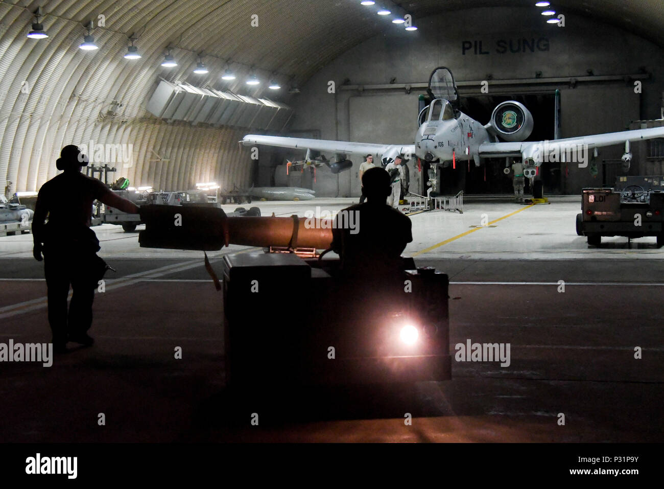 Weapons loaders from the 25th Aircraft Maintenance Unit use a MJ1C ...