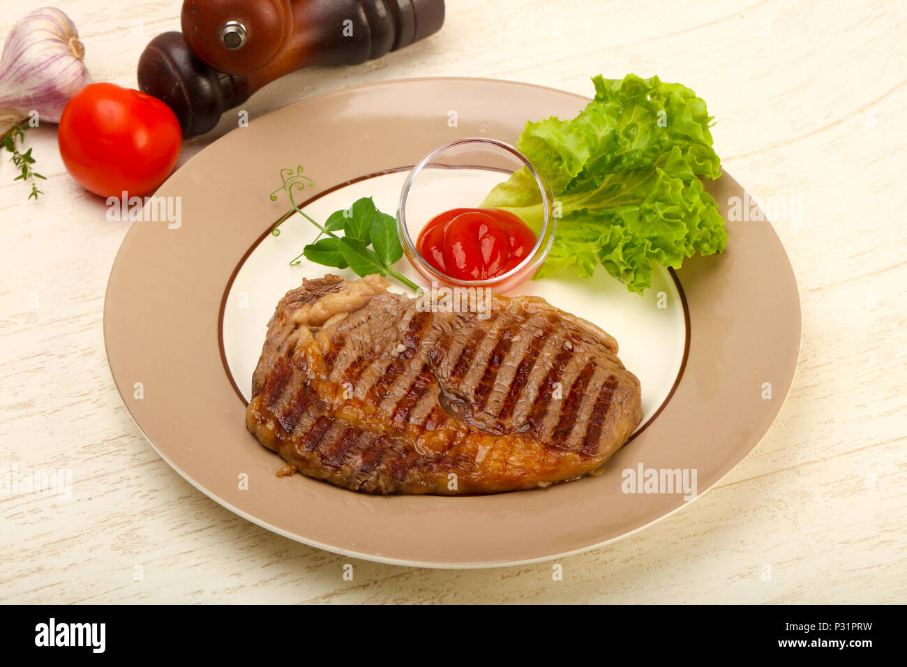 Grilled Rib eye steak with sauce Stock Photo - Alamy