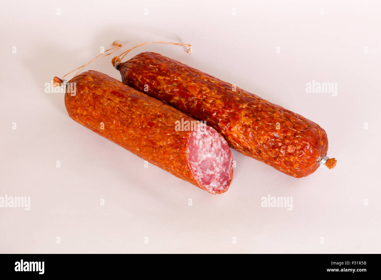 Two Salamy sausages isolated Stock Photo - Alamy