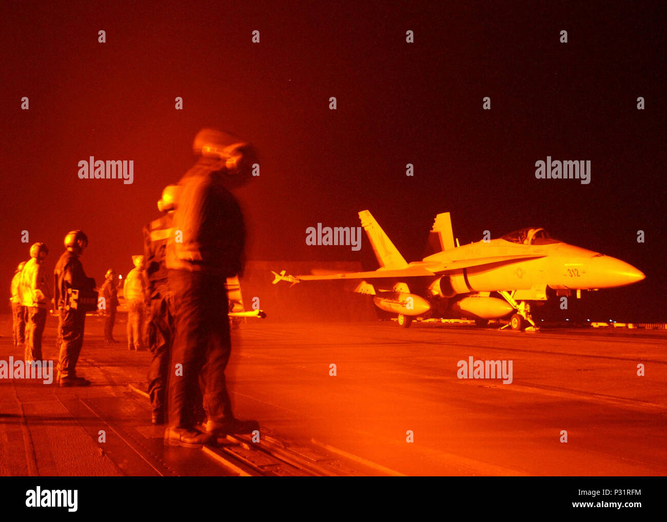USS Theodore Roosevelt (CVN 71) Jan. 7, 2002 -- Flight deck crewmembers ...