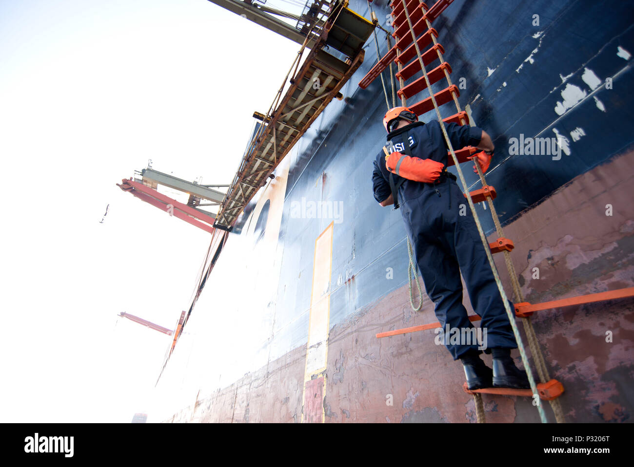 Lt. j.g. Ryan Szabo climbs a container ship's jacob's ladder during ...